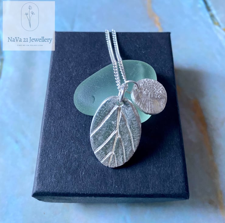 Silver leaf textured pendant with a small flowe... - Folksy