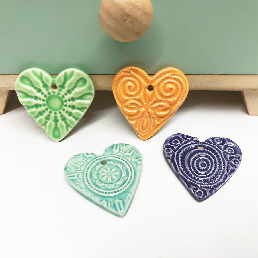 Set of four handmade ceramic heart pendants - Folksy