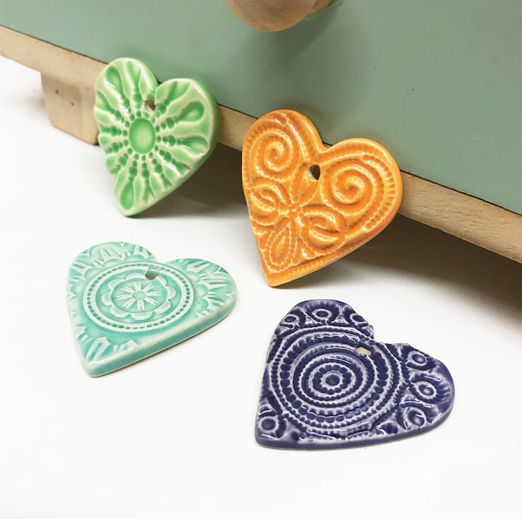 Set of four handmade ceramic heart pendants - Folksy