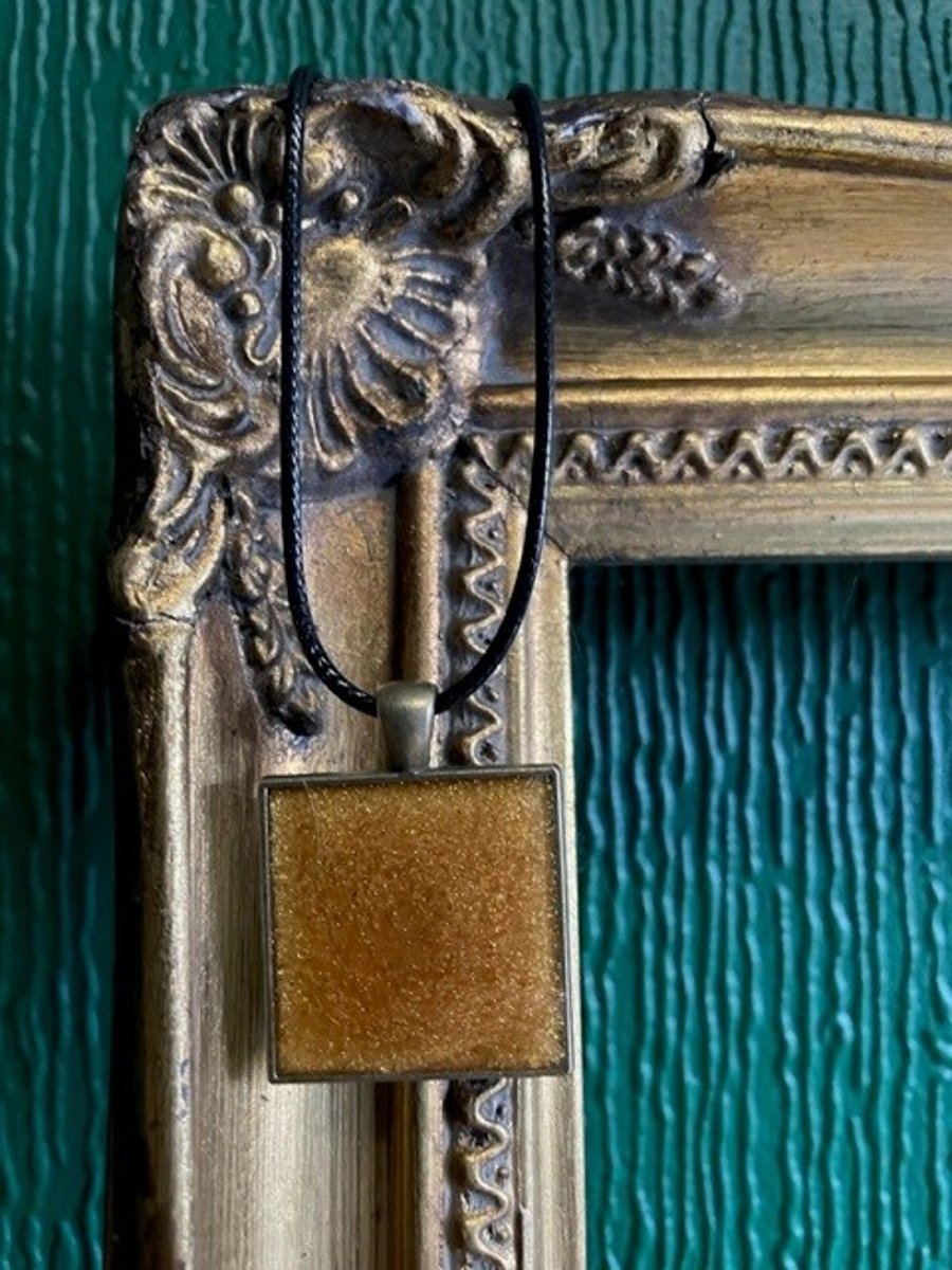 Resin amber square on dark bezel with cord - Folksy