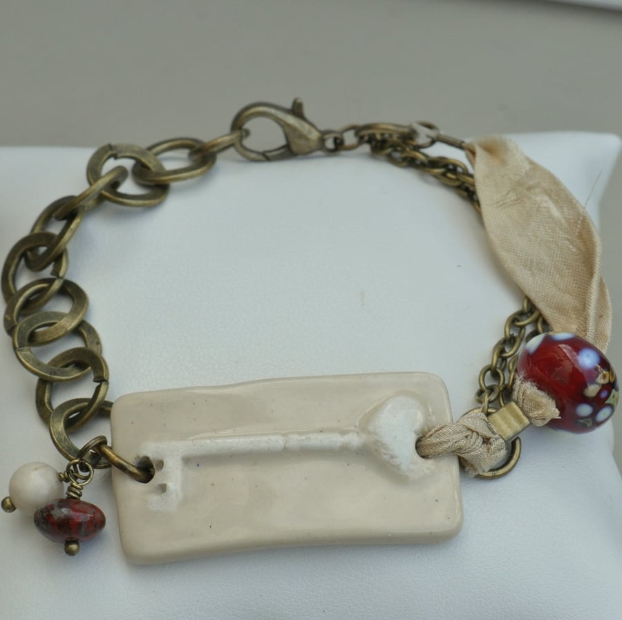 Handmade Cream Ceramic Key Bar with Lampwork Gl... - Folksy