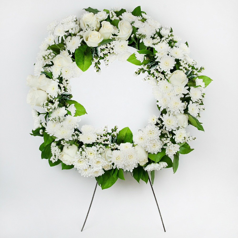 White mourning wreath with roses and chrysanthemums