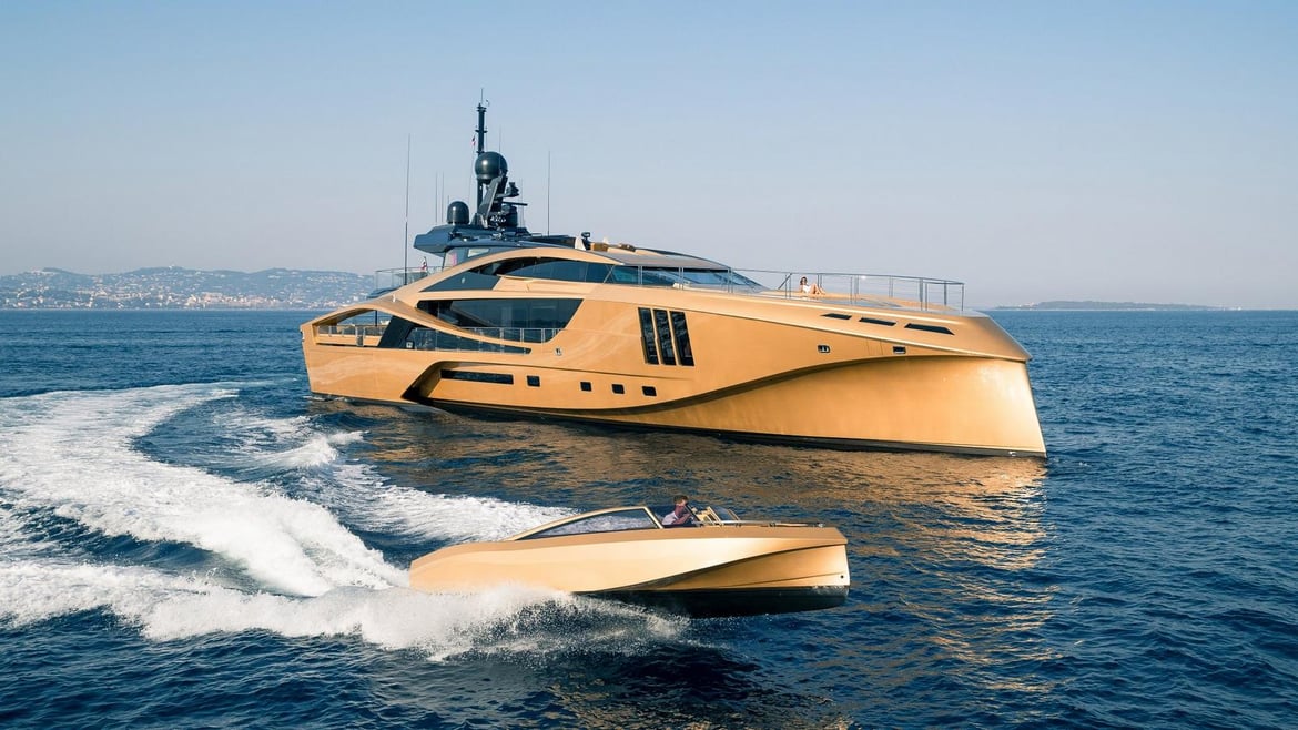 This 160-feet superyacht with a glistening gold exterior is the ...