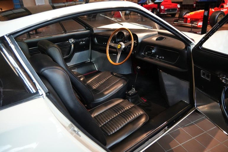 This is a three-seater Ferrari with the steering wheel placed in the ...