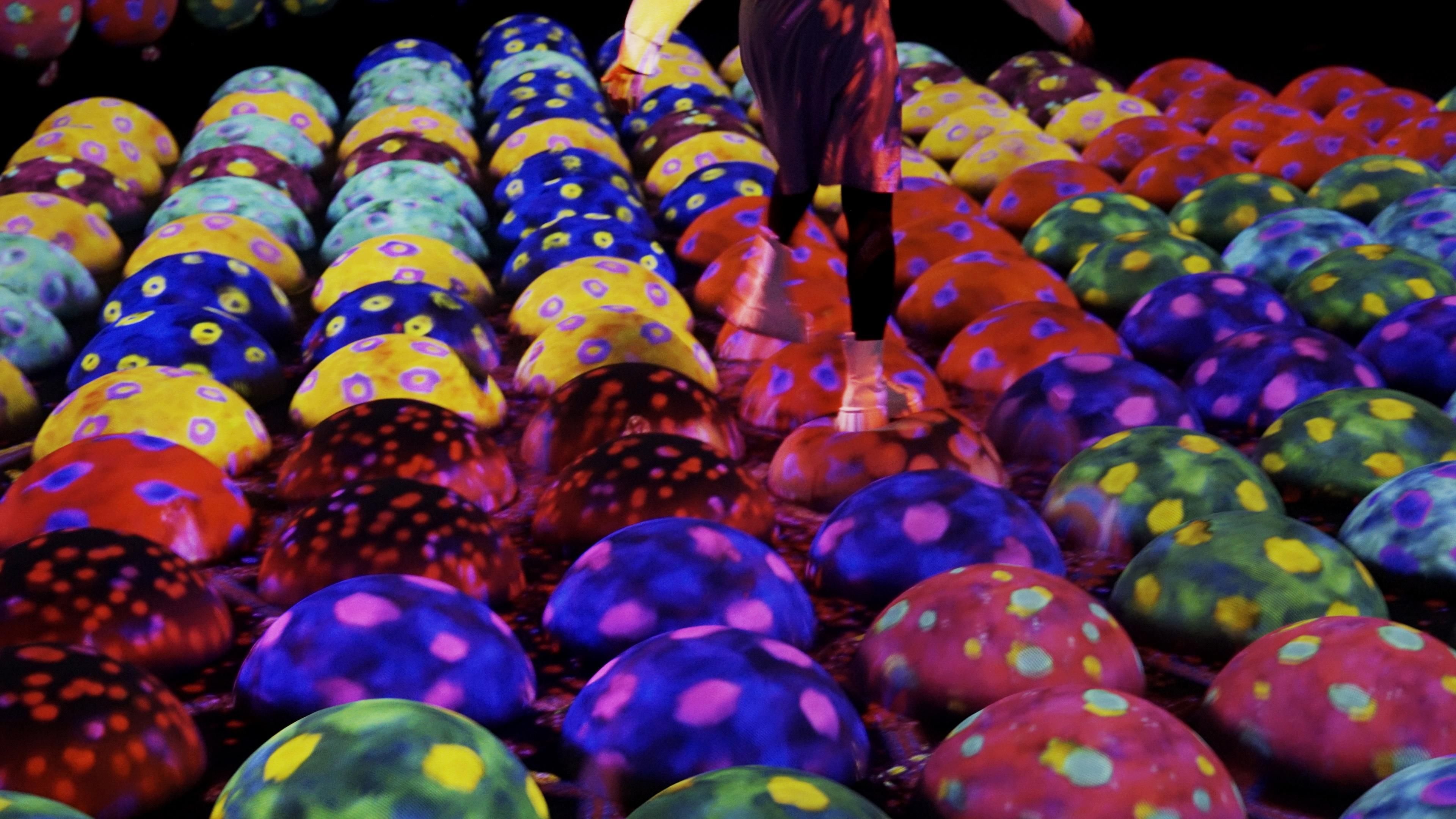 Rapidly Rotating Bouncing Spheres in the Caterpillar House | teamLab