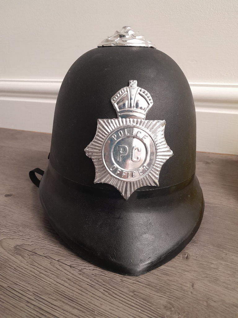 2 dressing up helmets. A police officers helmet and a builders hard hat ...