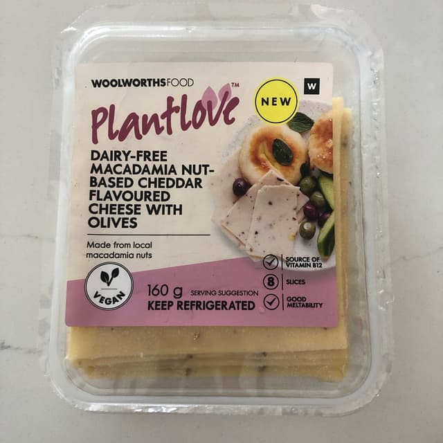 Dairy free Macadamia-nut based cheddar flavoured cheese with olives ...
