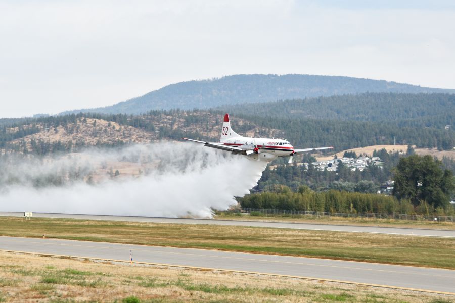 Air tanker performs final water drop over YLW before retirement
